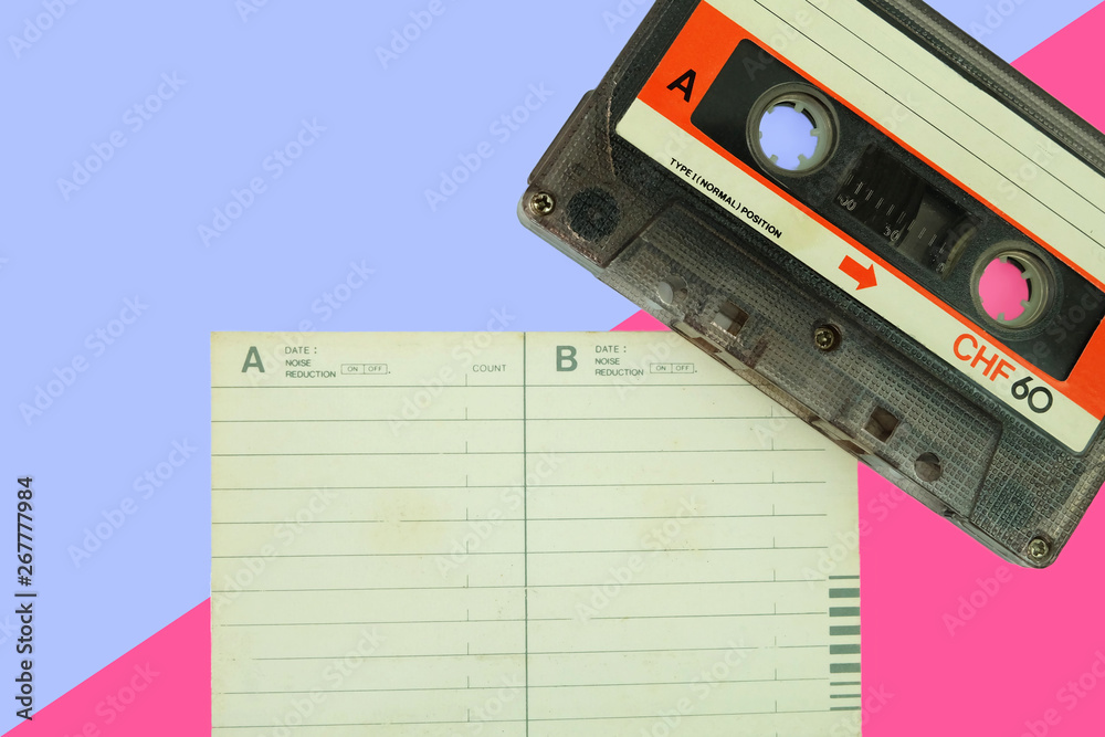 Old cassette tape audio with paper to write song name and text on pink ...