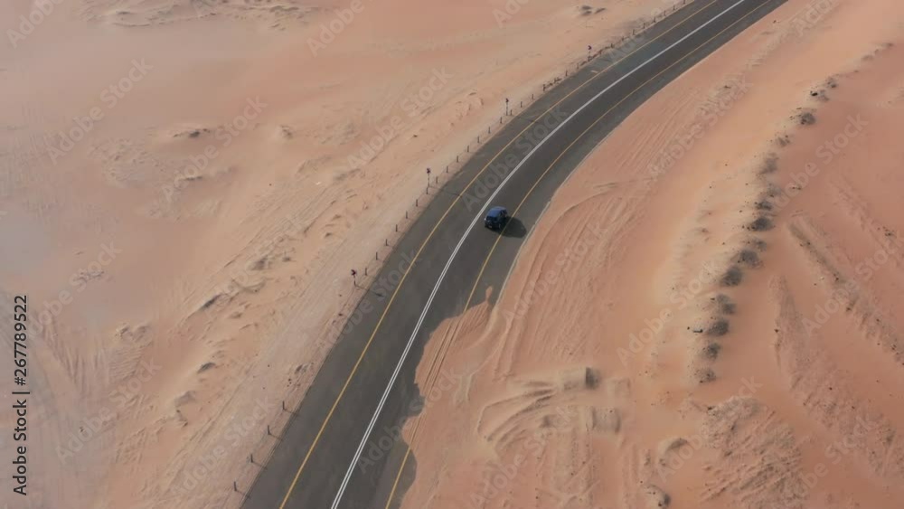 Sky view of car driving in desert. Aerial view of road in desert ...