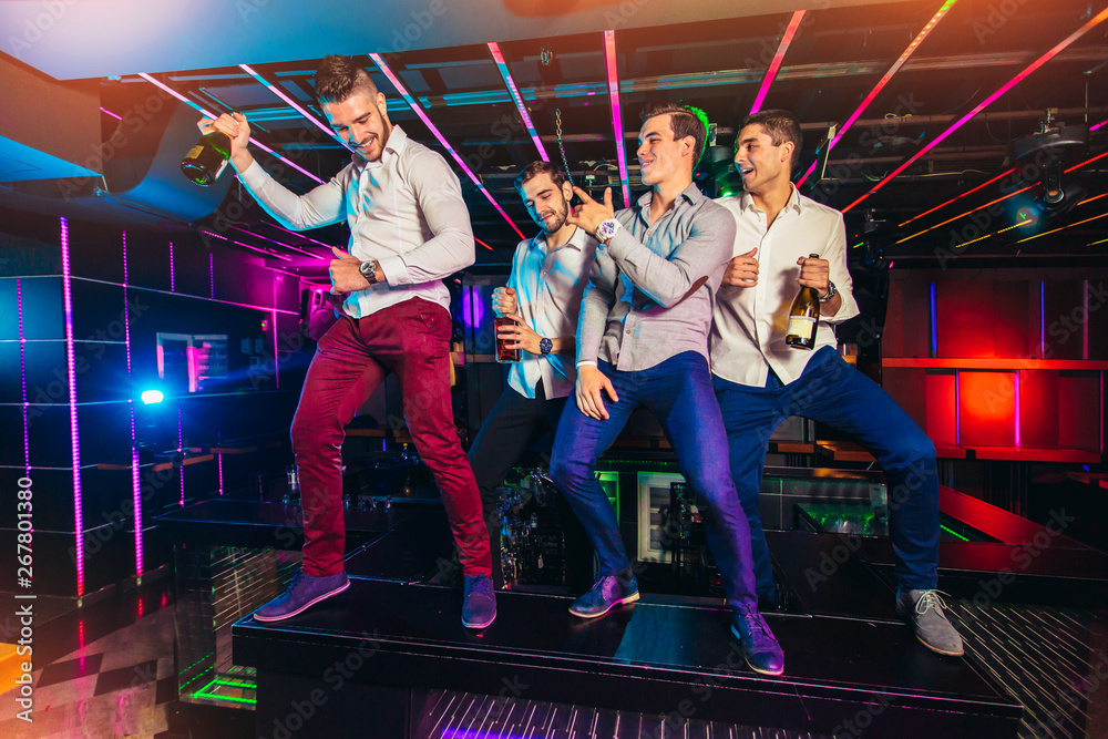 Group of smiling male friends having fun in night club Stock Photo ...