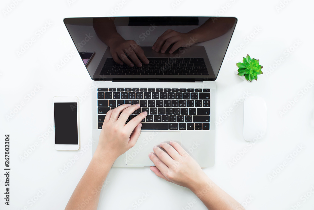 The top view of human hands, printed on a laptop computer on a modern ...