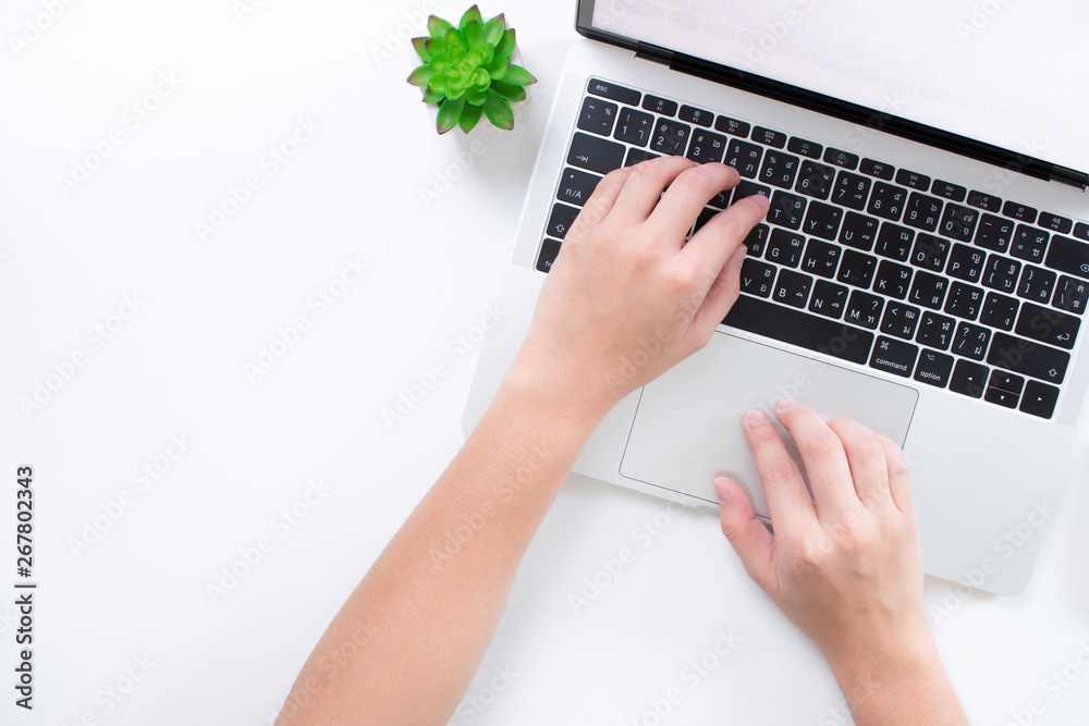 Human hands on a modern style white desk with a laptop computer, top ...