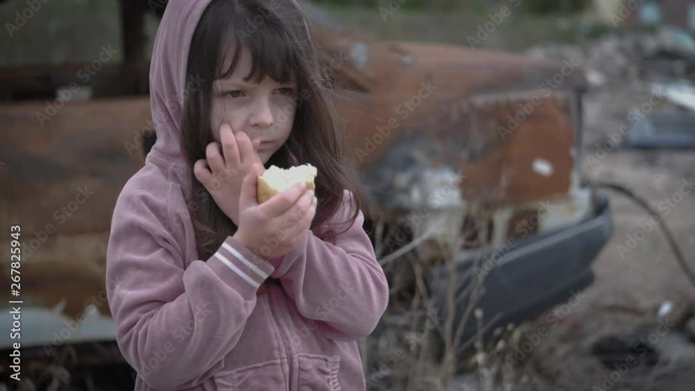 Homeless child with bread. Hungry homeless child. Little orphan girl ...