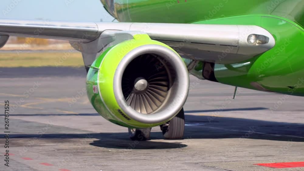 Jet turbine engine of aircraft on runway in airport. Working jet engine ...