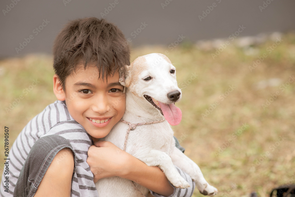 Little boy hug his dog jack russell in the park Stock Photo | Adobe Stock