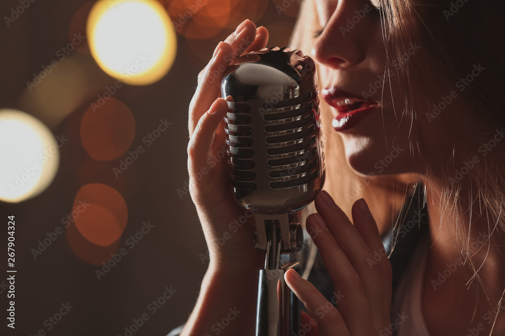 Beautiful female singer with microphone on stage, closeup Stock Photo ...