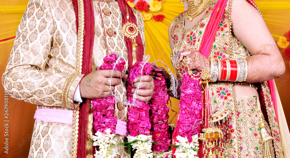 The bride and groom at the Indian wedding garlands or Jaimala ceremony ...