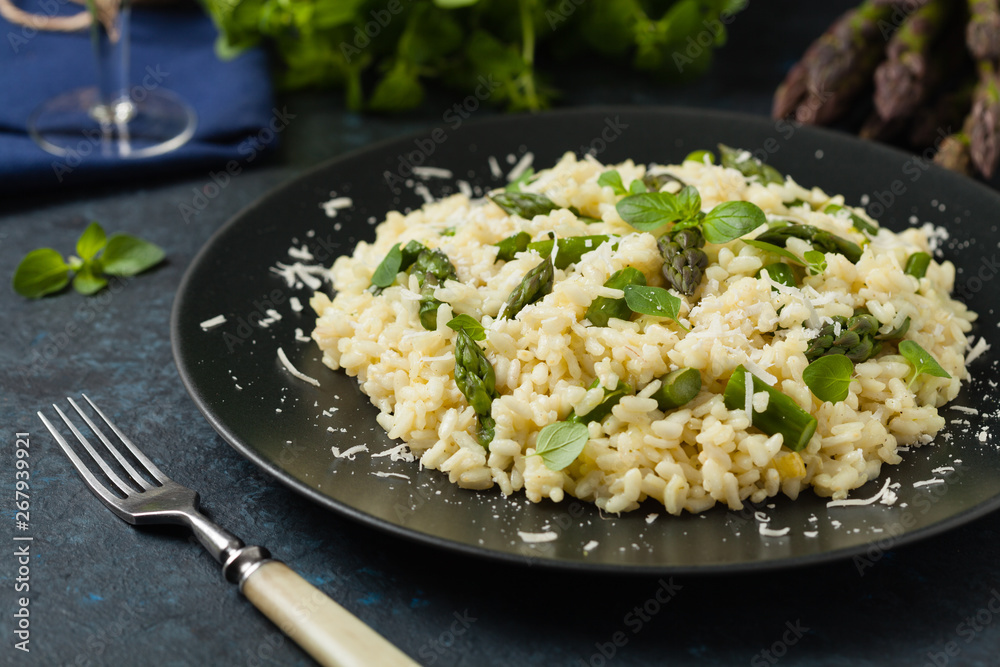 Classic Italian risotto with asparagus. Front view. Darkblue background ...