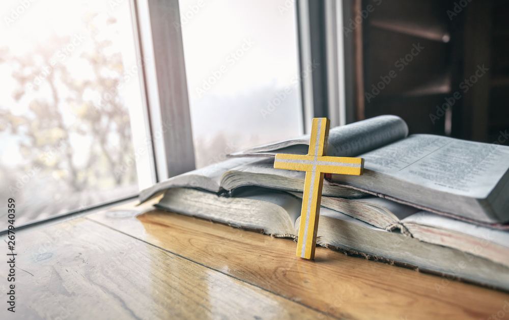 standing yellow cross with Bible. symbol of christian concept. Stock ...