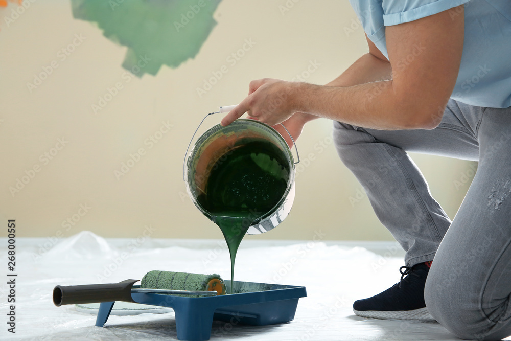 Pouring Paint Into A Bucket