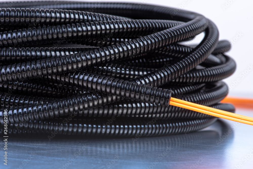 Cable with black flexible corrugated tube Stock Photo | Adobe Stock