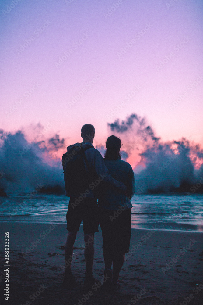 People on beach at sunset Stock Photo | Adobe Stock
