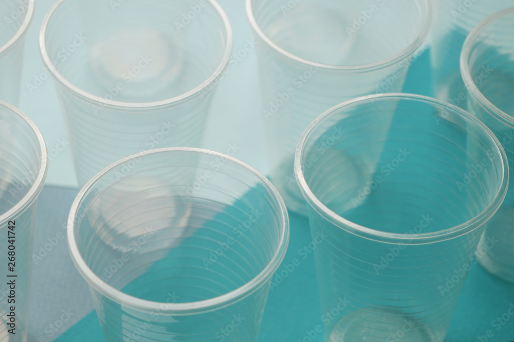 Disposable plastic cups on a blue and white background. Concept of ...