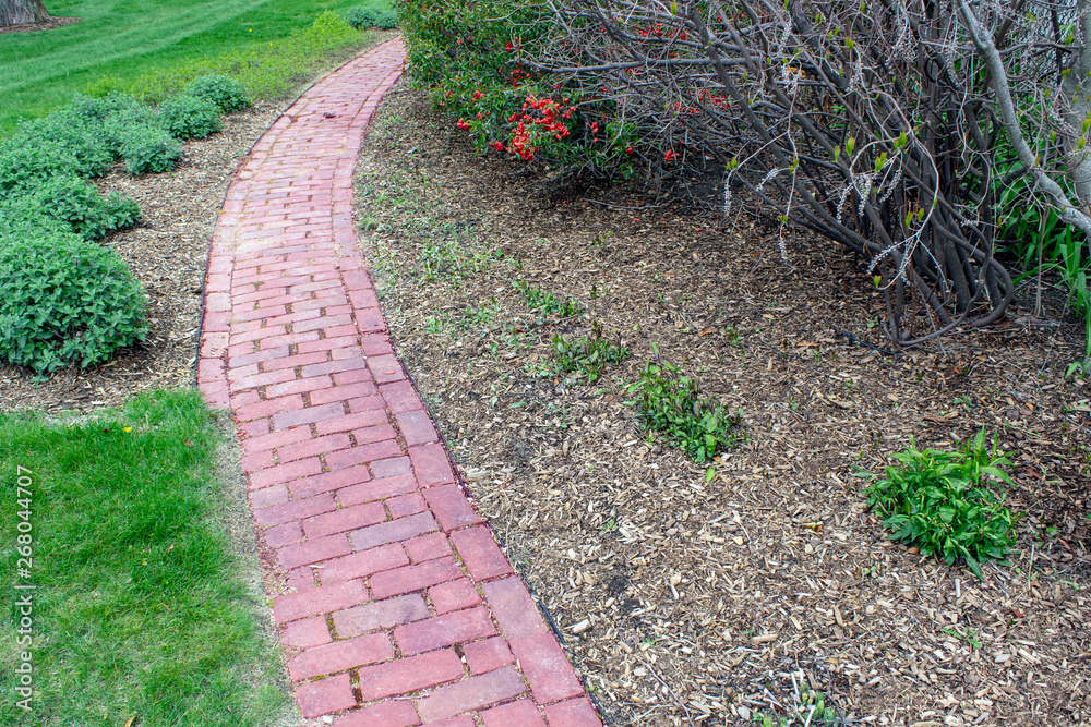 curved brick path in landscaping disappears around corner Stock Photo ...