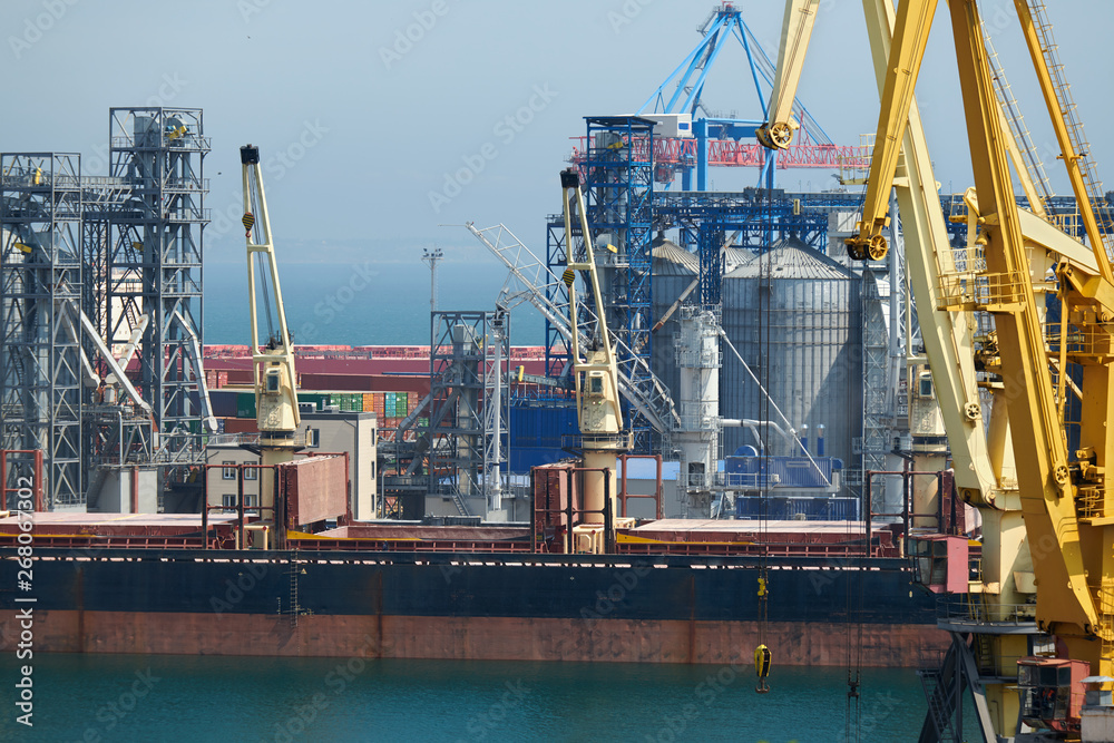 Industrial port, infrastructure of seaport, cranes and dry cargo ships ...