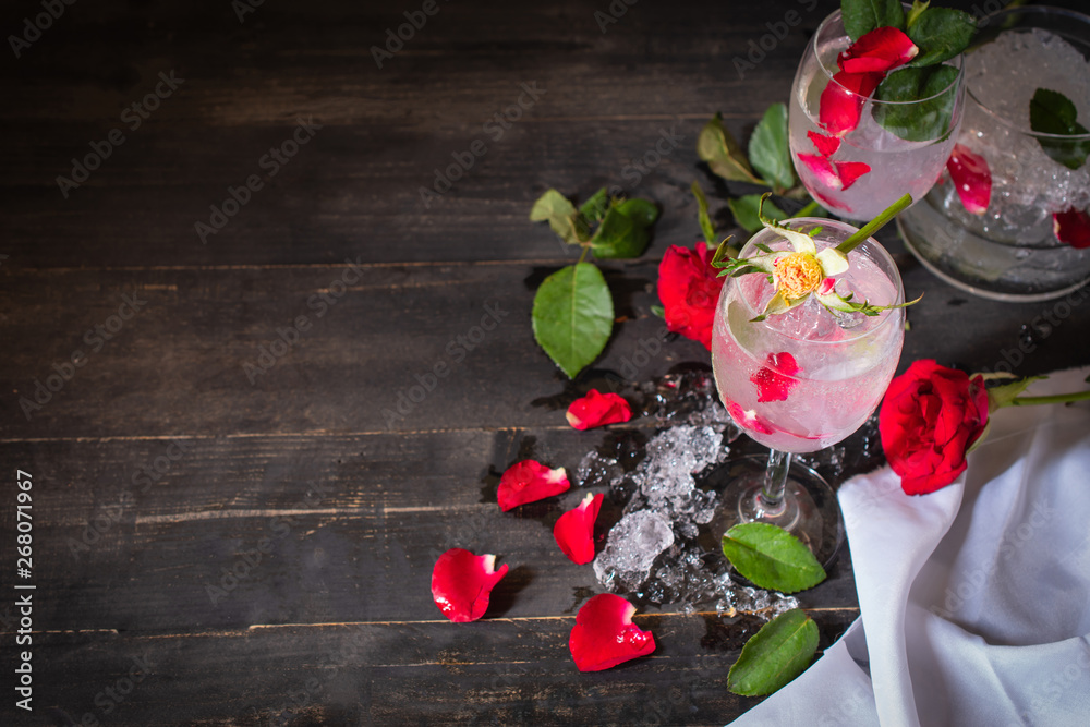 Sparkling cold water detox with rose and ice on the wood table there ...