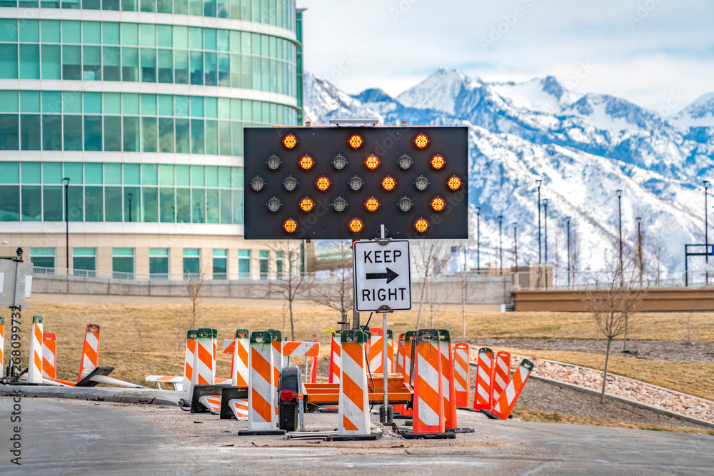 Keep Right sign underneath an arrow board surrounded by road safety ...