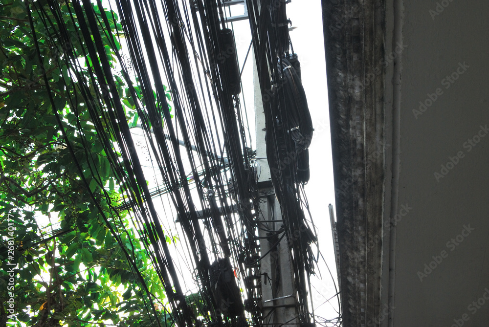 Power lines and cables that are cluttered on electric poles Stock Photo ...