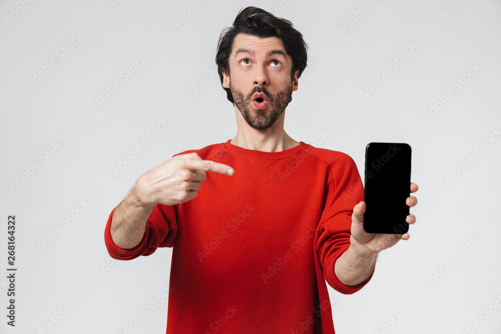 Handsome young man posing isolated over white wall background showing ...