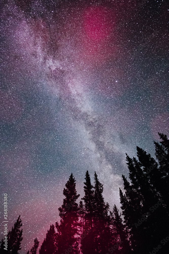 Pink light flares underneath milky way galaxy night sky. Stock Photo ...