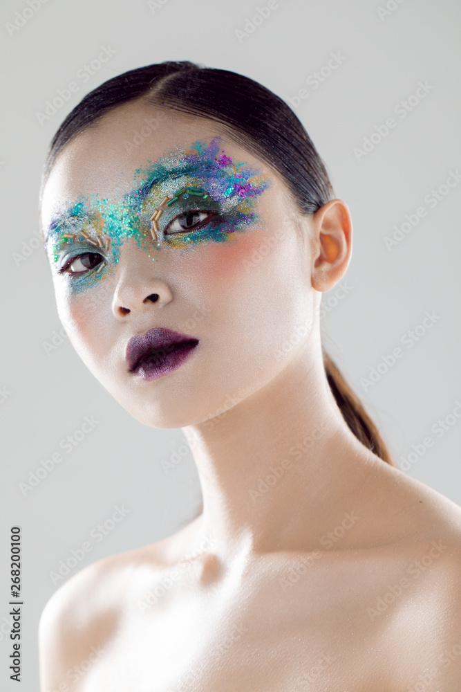 Beautiful model posing in a studio with glitter makeup Stock Photo ...