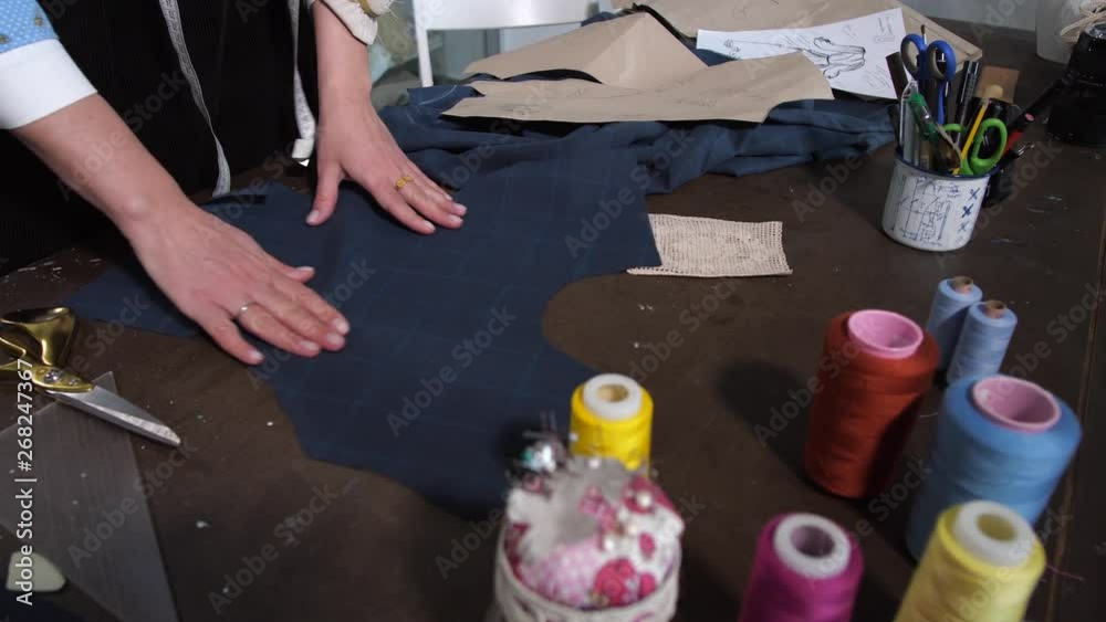 Close-up of female tailor hands trying on knitted lace decoration to ...