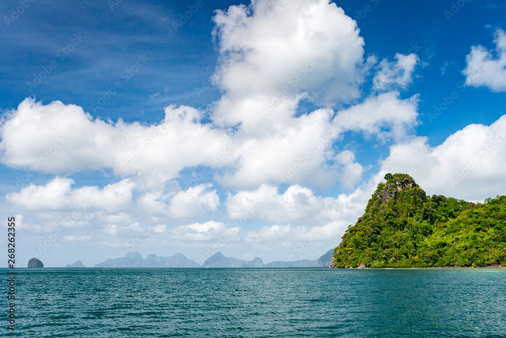 Pristine beach on a secluded green island with limestone cliffs and ...