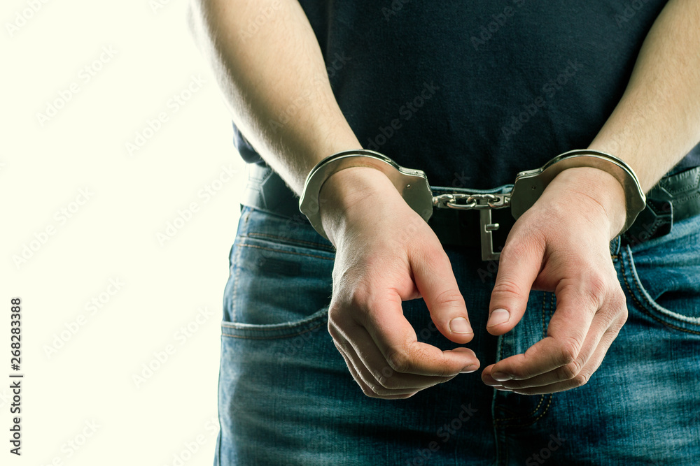 Adult male arrested and handcuffed.Man under Arrest. Hands with ...
