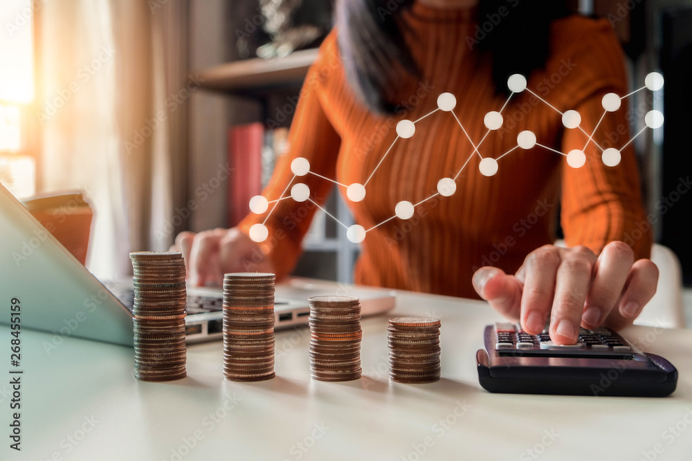 accountant working on desk in office using calculator and laptop to ...