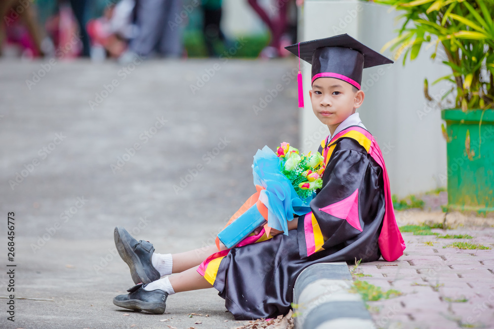 Graduation children receive a certificate. Stock Photo | Adobe Stock