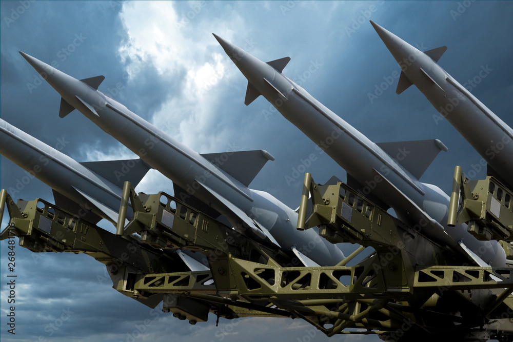 Antiaircraft rockets on the launcher against dramatic sky. military ...
