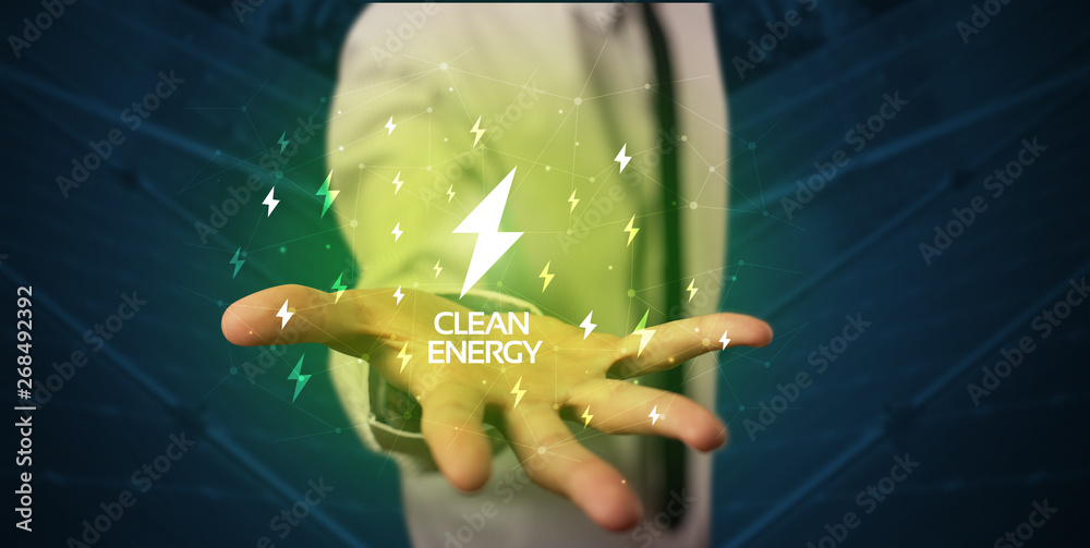 Hand in suit holding lightning bolt on his hand, green environment ...