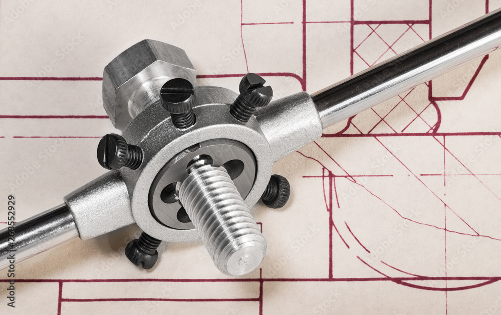 Threading die in tap wrench on technical drawing detail. Steel cutting ...