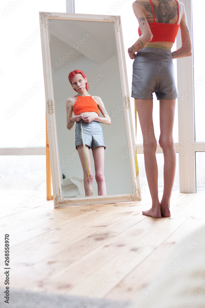 Extremely skinny and slim anorexic woman looking into mirror Stock ...
