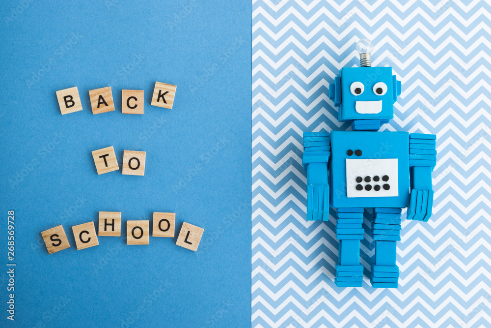 Back to school concept. A metal robot and an electronic board that can ...