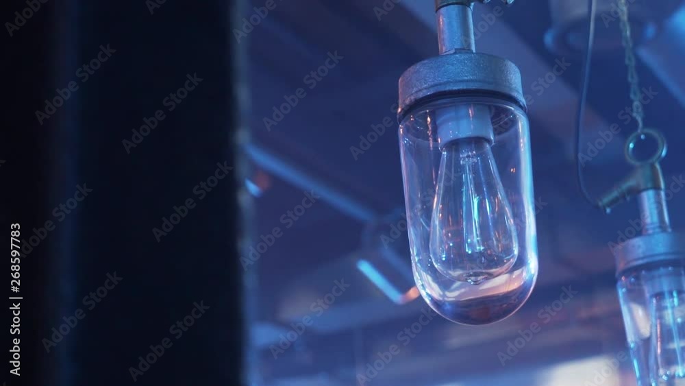 Two beautiful stylish switched off lamps with long lightbulbs covered ...