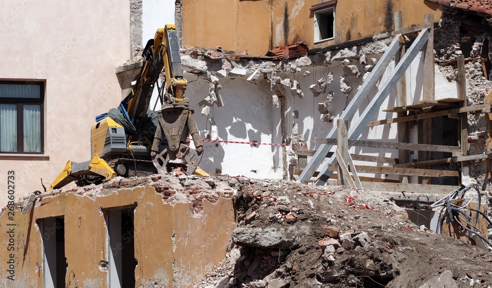 Mini excavator at work on the first floor of a building under complete ...