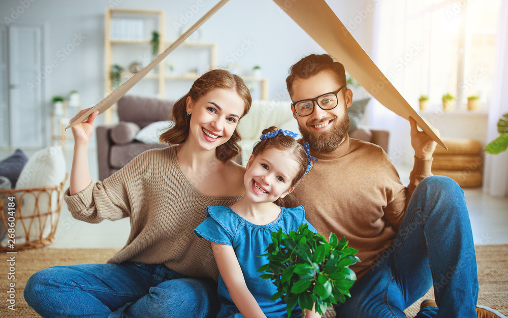 concept housing young family. Mother father and child in new house with ...