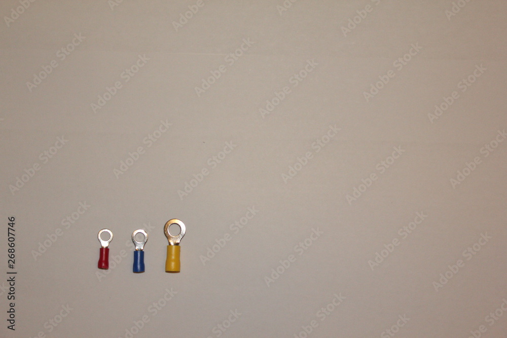 cable lugs with differents colours and sizes on a white background, for ...