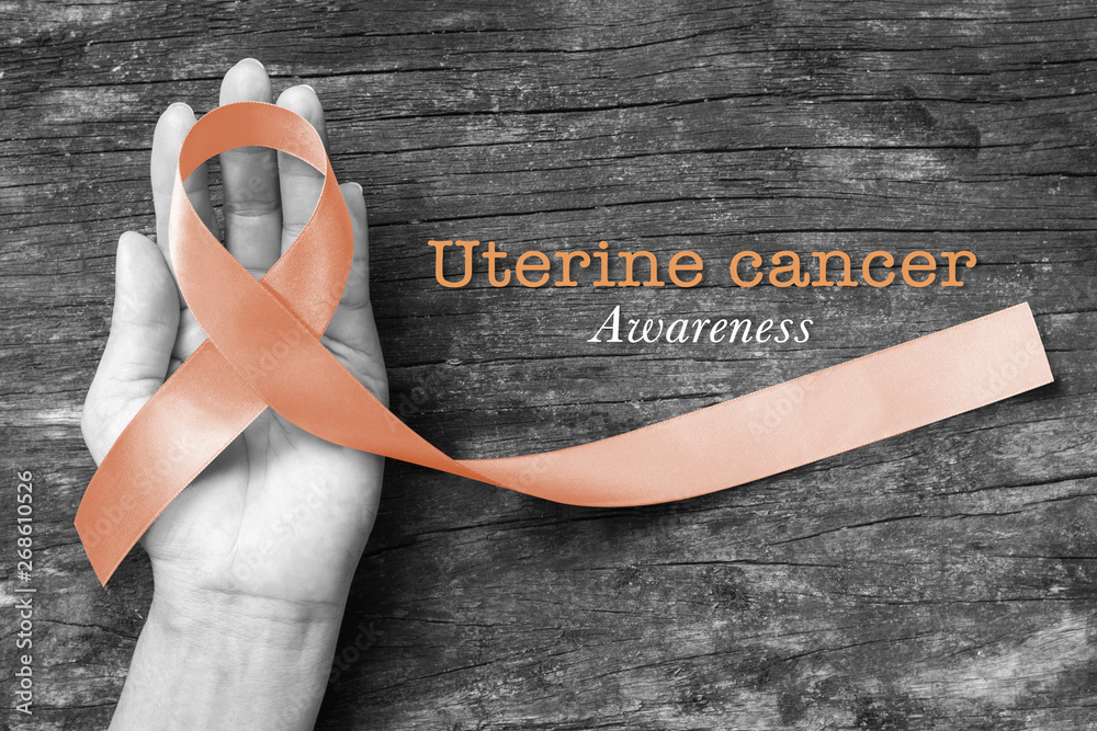 Uterine and Gynecologic Cancer Awareness peach color ribbon on woman’s ...