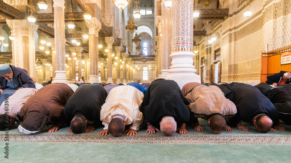 Plakát Muslim men bowing, kneeling and praying inside of a big mosque ...