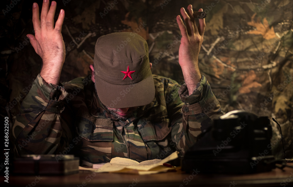 The evil dictator sitting on table. Angry communist general sitting at ...