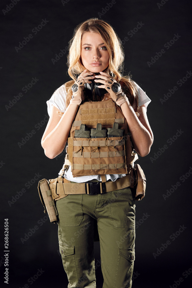 Gorgeous young woman with long blonde hair wearing Military gear ...