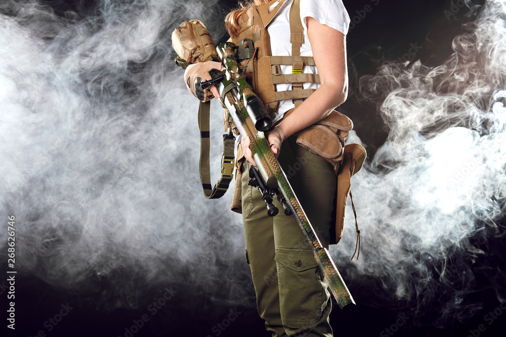 Woman soldier in military camouflage uniform protected with helmet ...