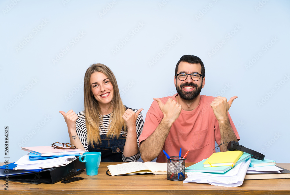 Students with many books with thumbs up gesture and smiling Stock Photo ...