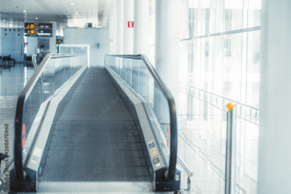 View of a modern travelator indoors of a railways station depot; moving ...