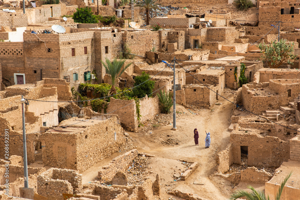 Two muslim female residents talking in ksar ksour castle in desert ...