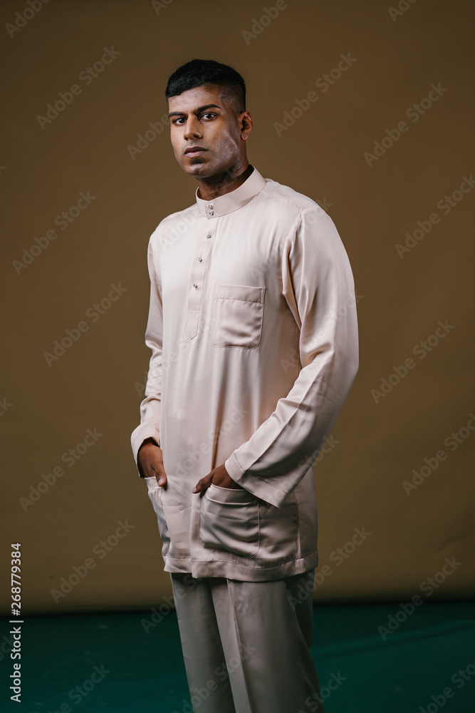 Studio portrait of a young, handsome and athletic Malaysian Indian ...