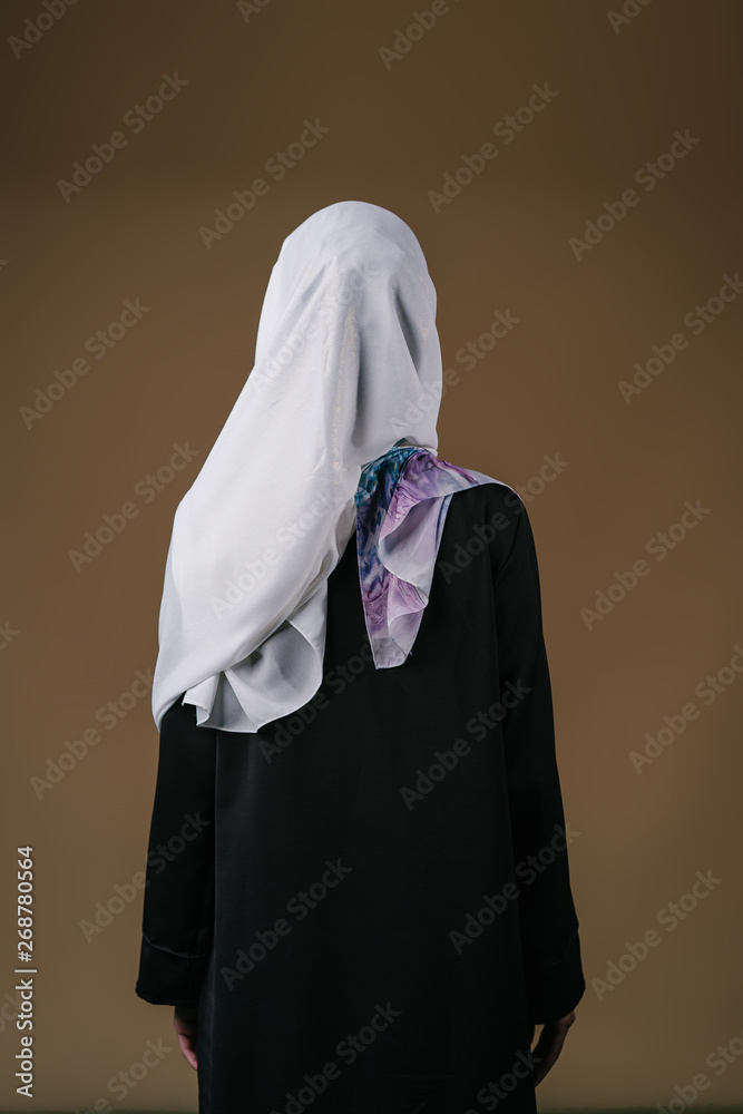 Portrait of a young, tall and slim Middle Eastern Muslim woman's back ...