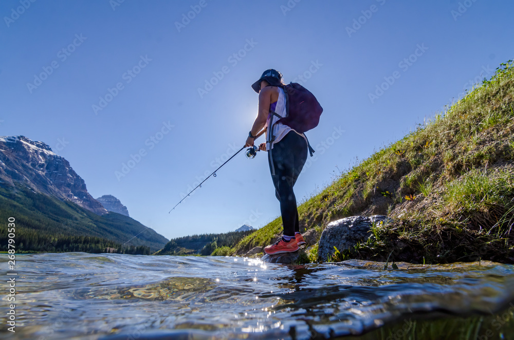 girl fishing in banff national park canada Stock Photo | Adobe Stock