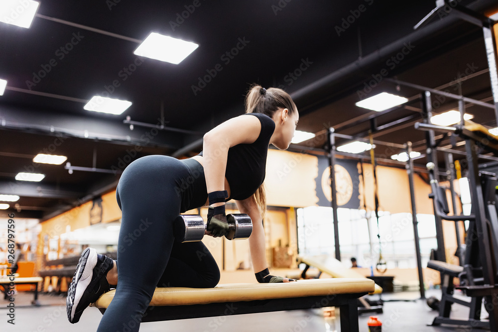 Beautiful young woman fitness instructor and champion work with ...